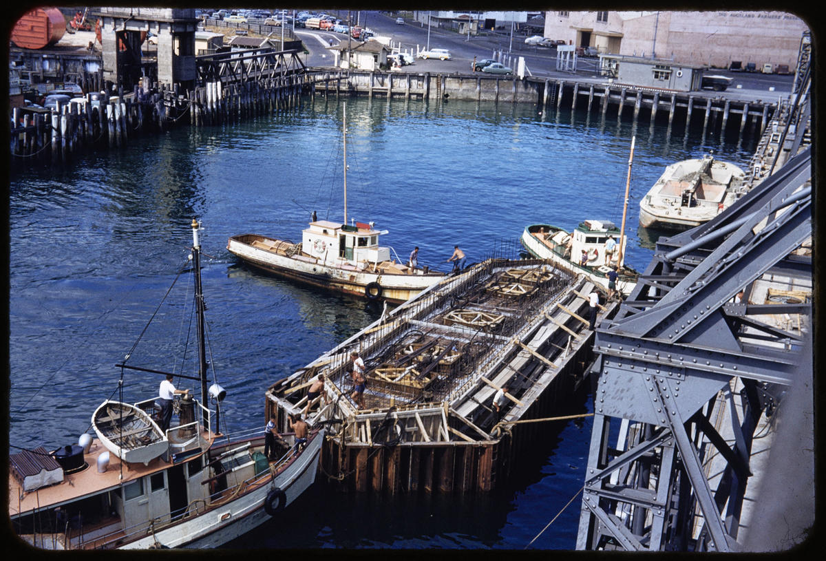Tugs maneuvering near caisson under construction - Museum of Transport ...