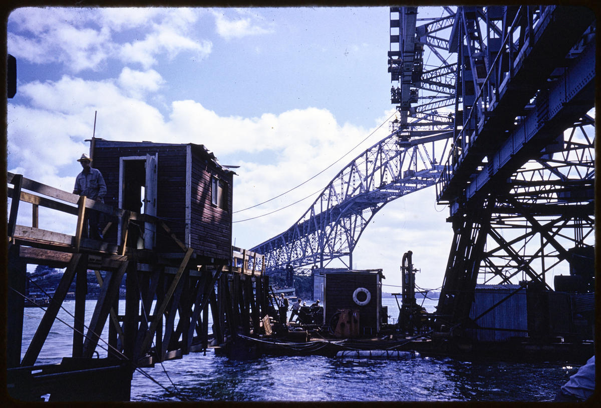 Barge carrying bridge structure moored alongside narrow gauge railway ...
